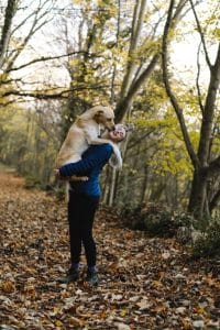 Why Does My Dog Stand Over Me: Uncanny Behavior Explained